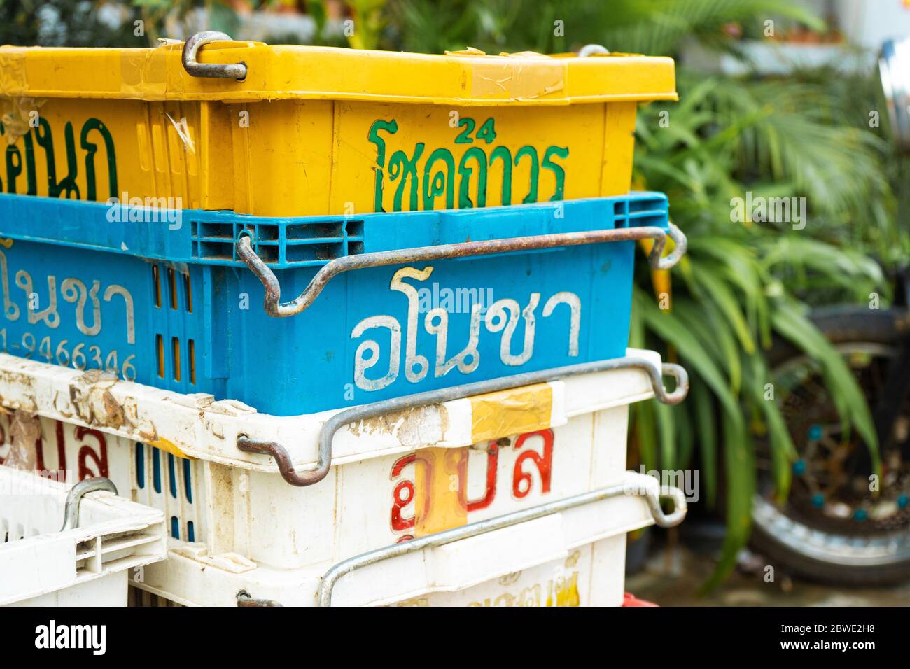 Plastic boxes for goods on the street near a greengrocery in Thailand ...