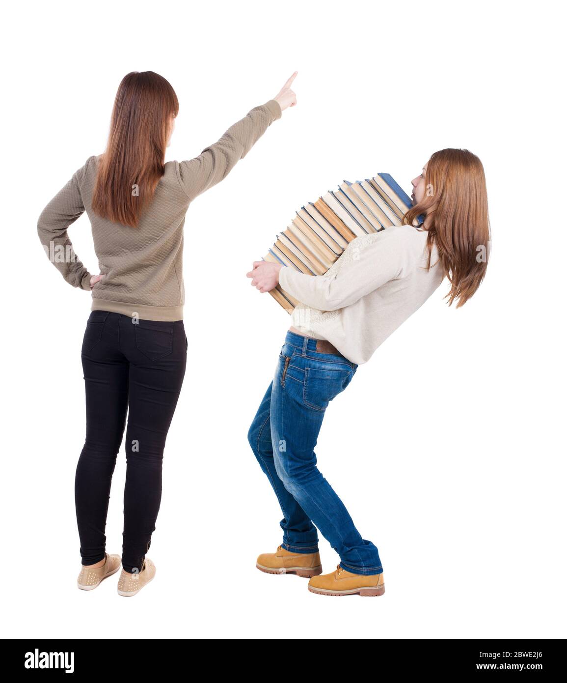 Back view of two young woman photographed on a mobile phone in sweater ...