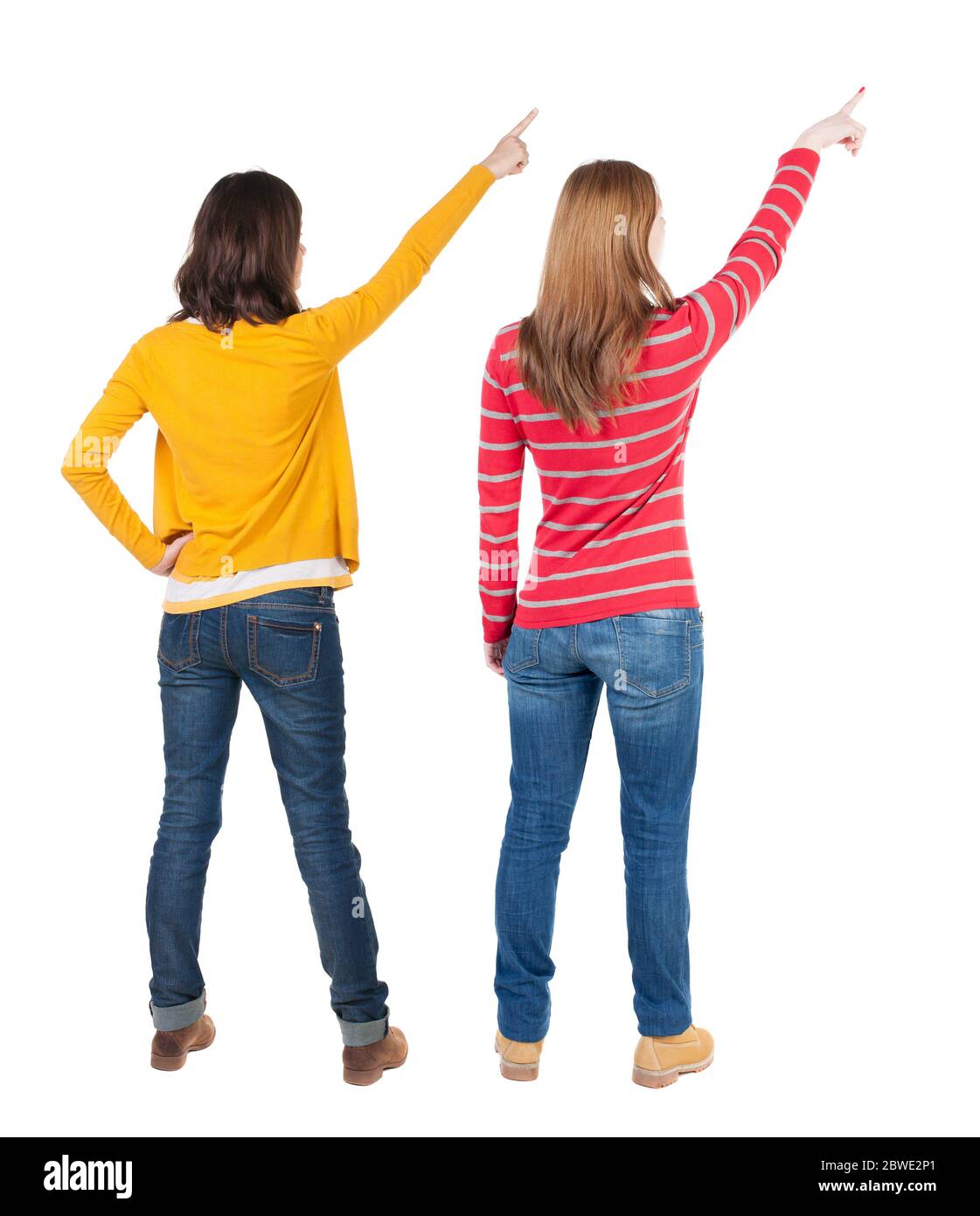 Back view of two young woman photographed on a mobile phone in sweater ...