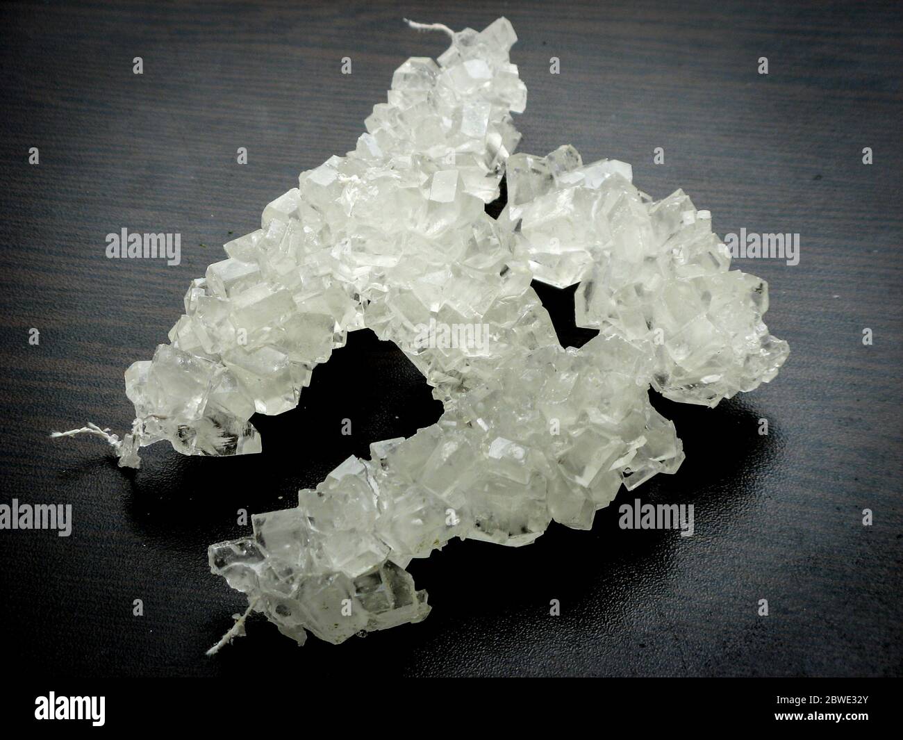 White nabat with black background , Iranian rock candy on a wooden ...