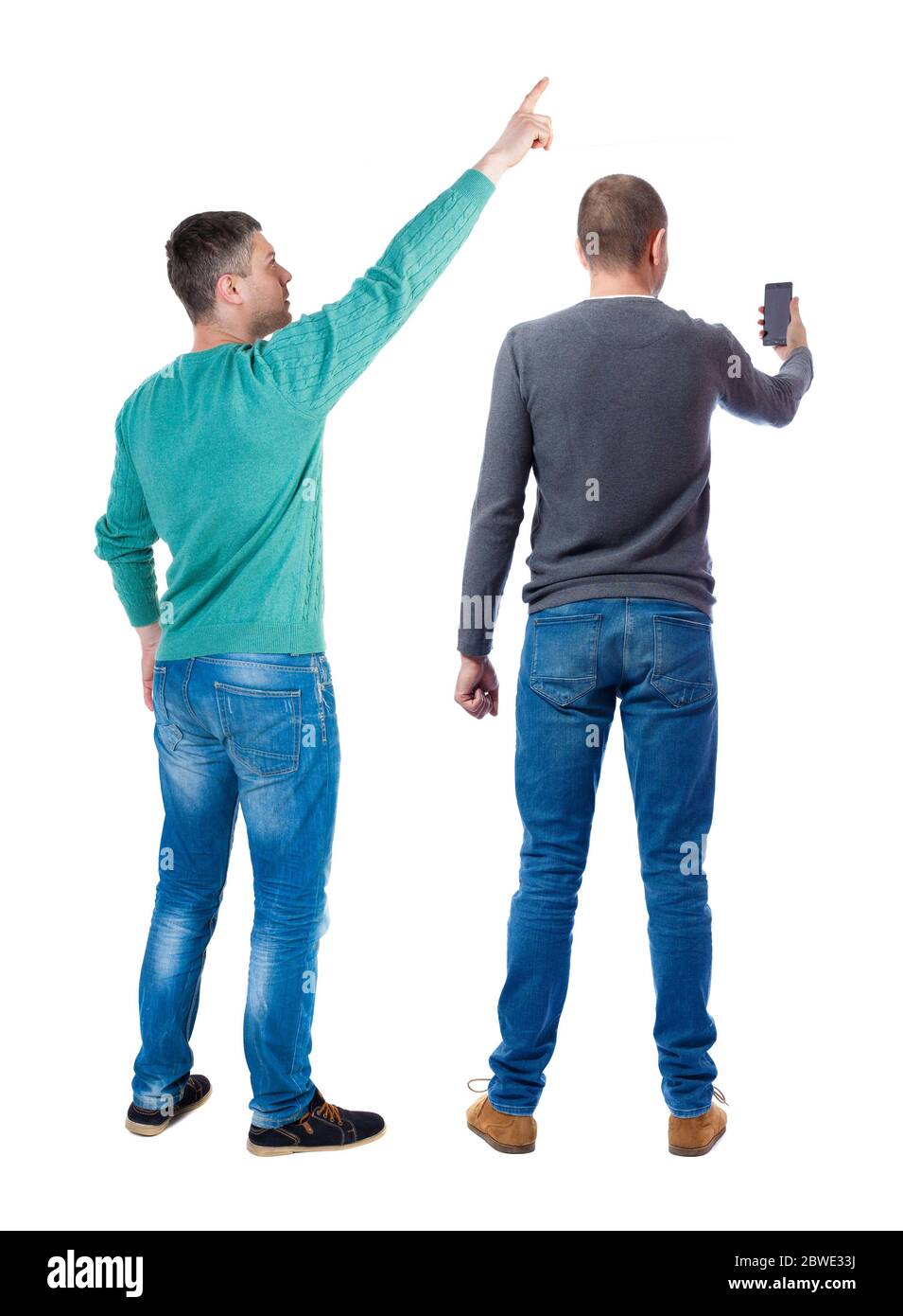 Back view of two man in sweater with mobile phone. Rear view people ...