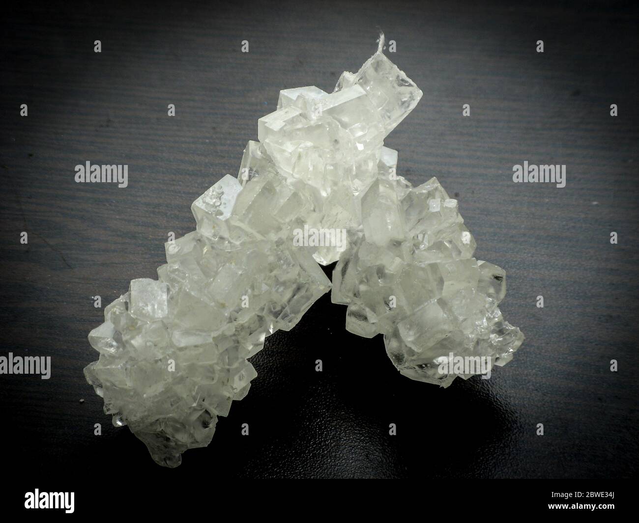White nabat with dark background , Iranian rock candy on a wooden table ...