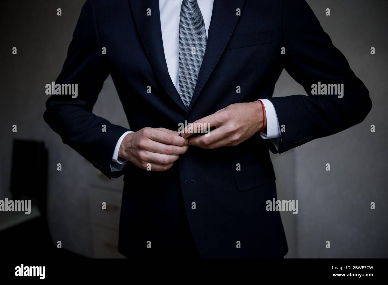 Man puts on suit jacket hi-res stock photography and images - Alamy