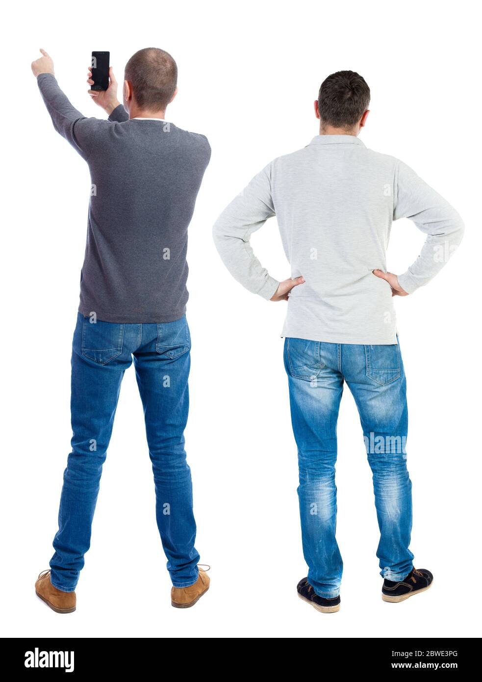 Back view of two man in sweater with mobile phone. Rear view people ...