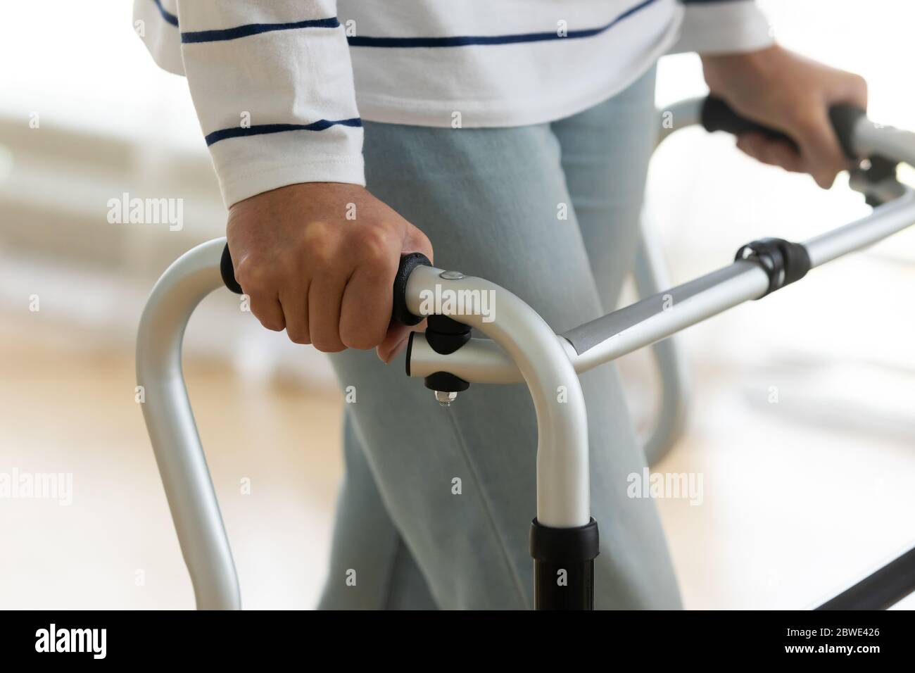 Old woman walking frame hi-res stock photography and images - Alamy
