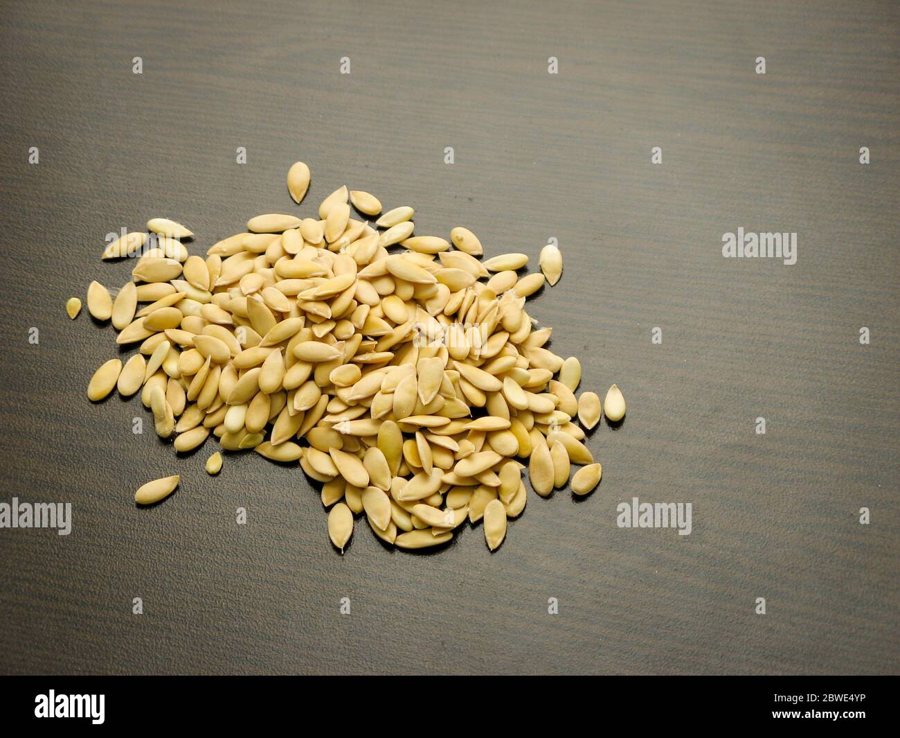 Close of edible dried raw organic seeds of white melon or cantaloupe on ...
