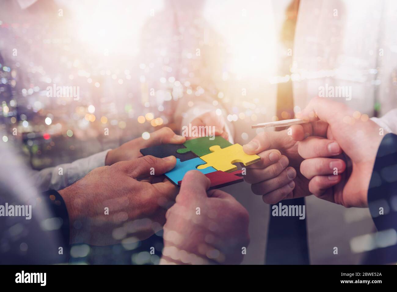 Teamwork of partners. Concept of integration and startup with puzzle ...