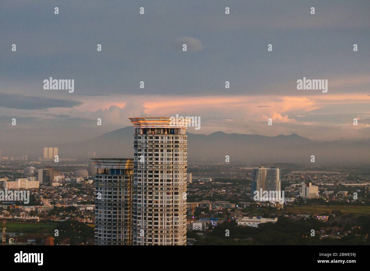 A building in focus with a mountain background covered in smog during ...