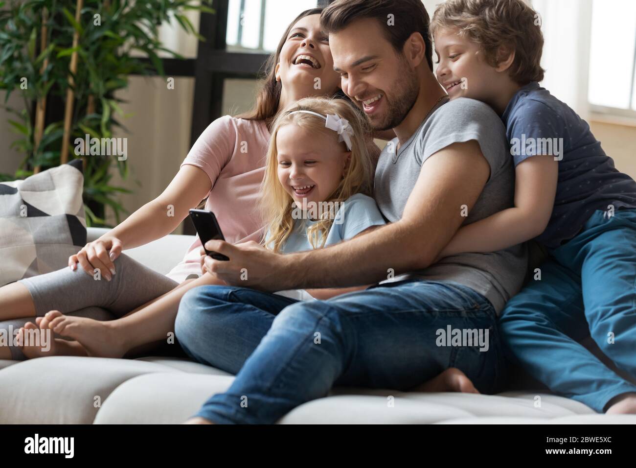 Children play parents watch hi-res stock photography and images - Alamy