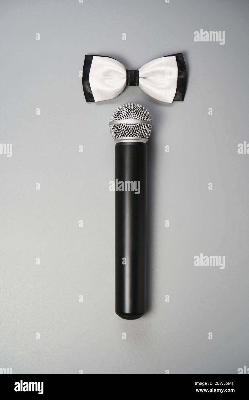 Boy and girl microphone concept. Grey background Stock Photo - Alamy
