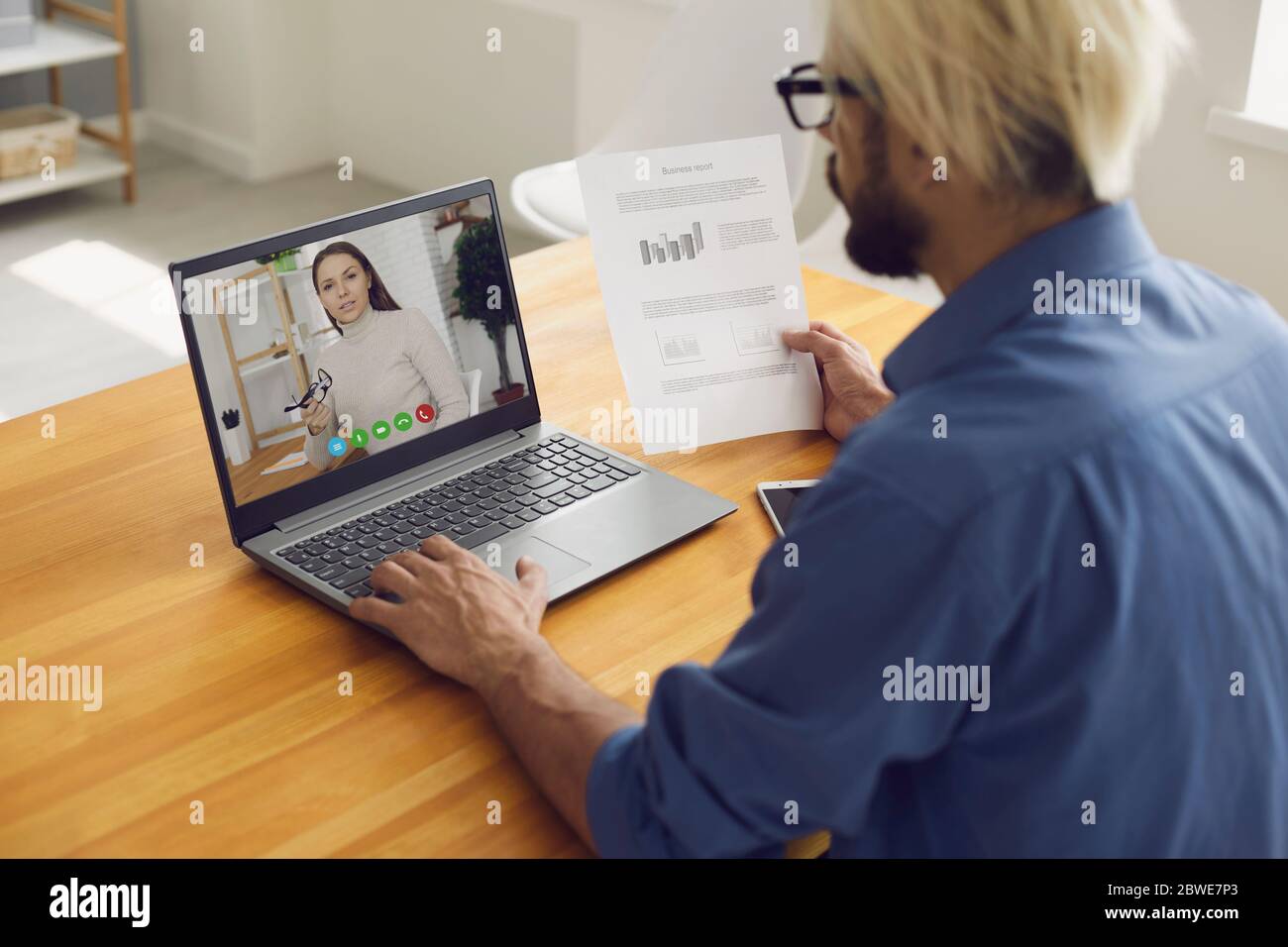Businessman having online meeting with coworker on laptop. Executive ...