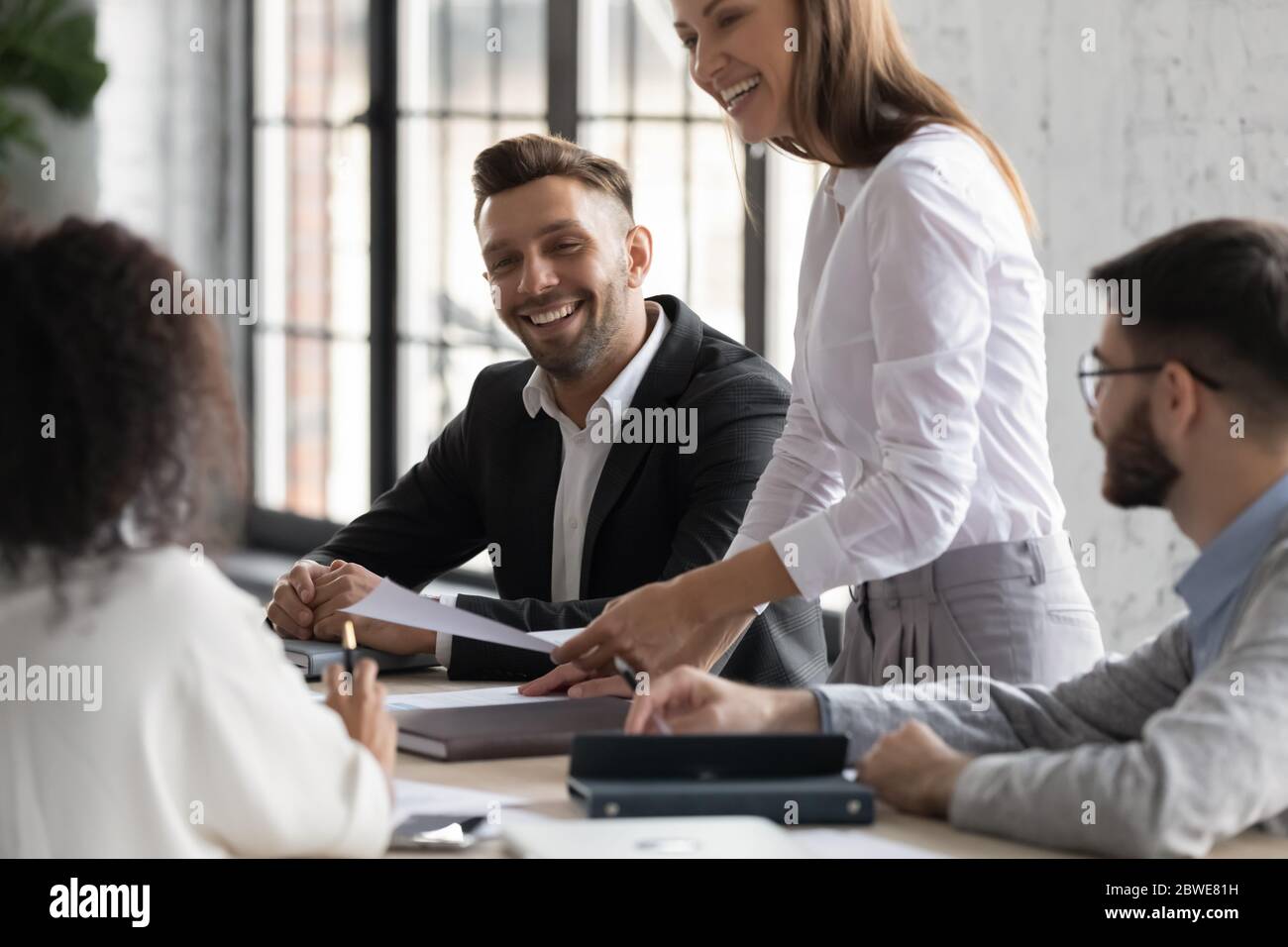 Happy diverse colleagues having fun at corporate meeting Stock Photo ...