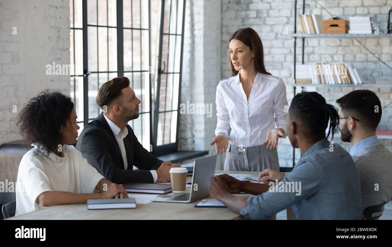 Confident successful businesswoman team leader speaking at briefing ...