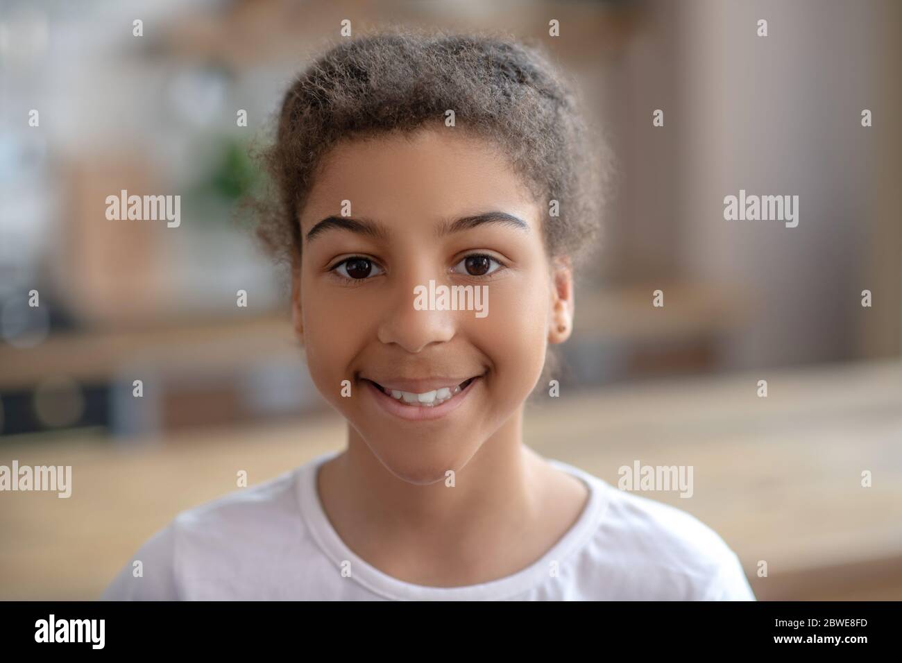 Cute curly-haired girl smiling and looking pleased Stock Photo - Alamy Cute curly-haired girl smiling and looking pleased Stock Photo - Alamy