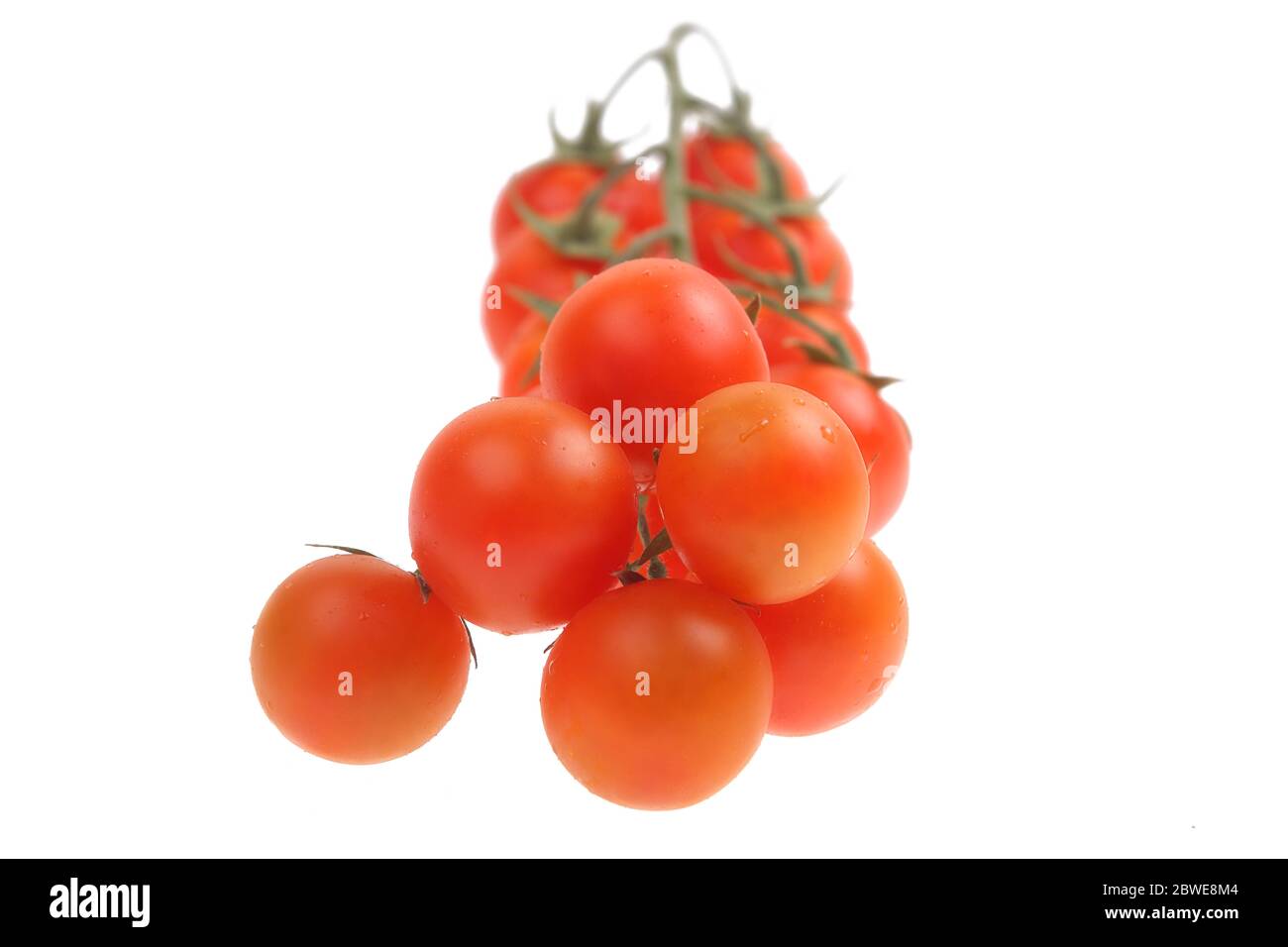 Bunch juicy cherry tomatoes Cut Out Stock Images & Pictures - Alamy