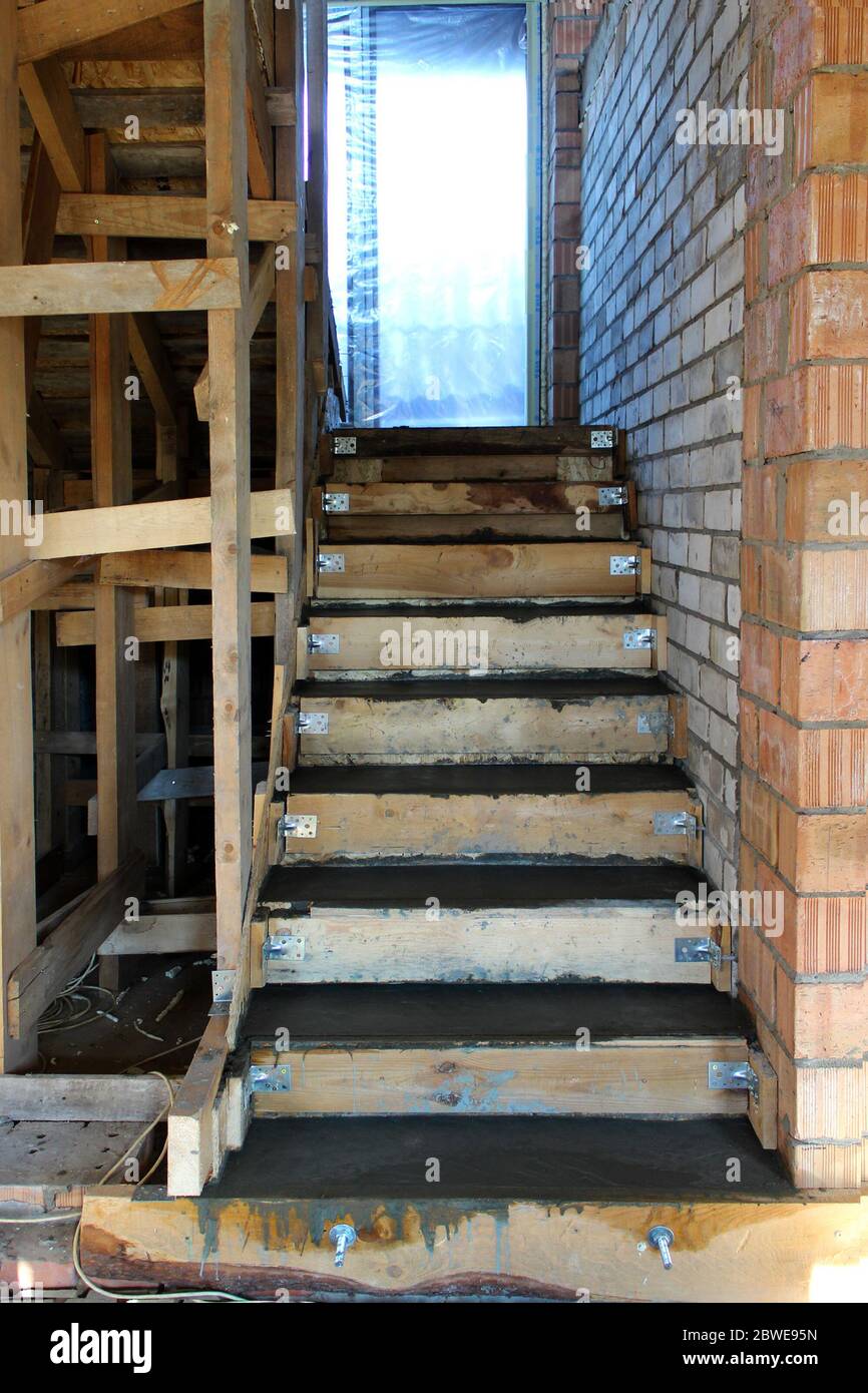 Metal reinforcement and wooden formworks of concrete stairway under ...
