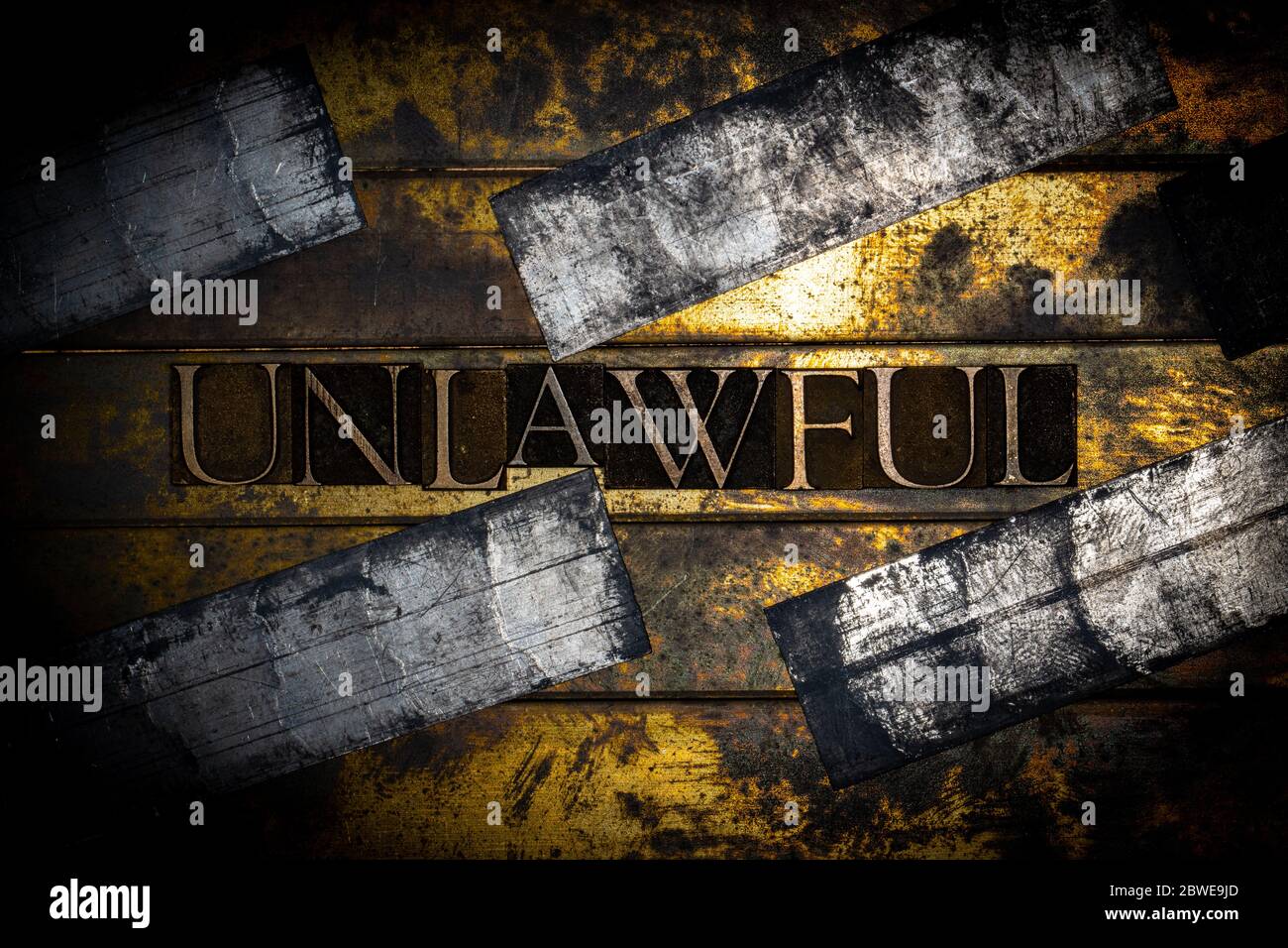 Photo of real authentic typeset letters forming Unlawful text on ...
