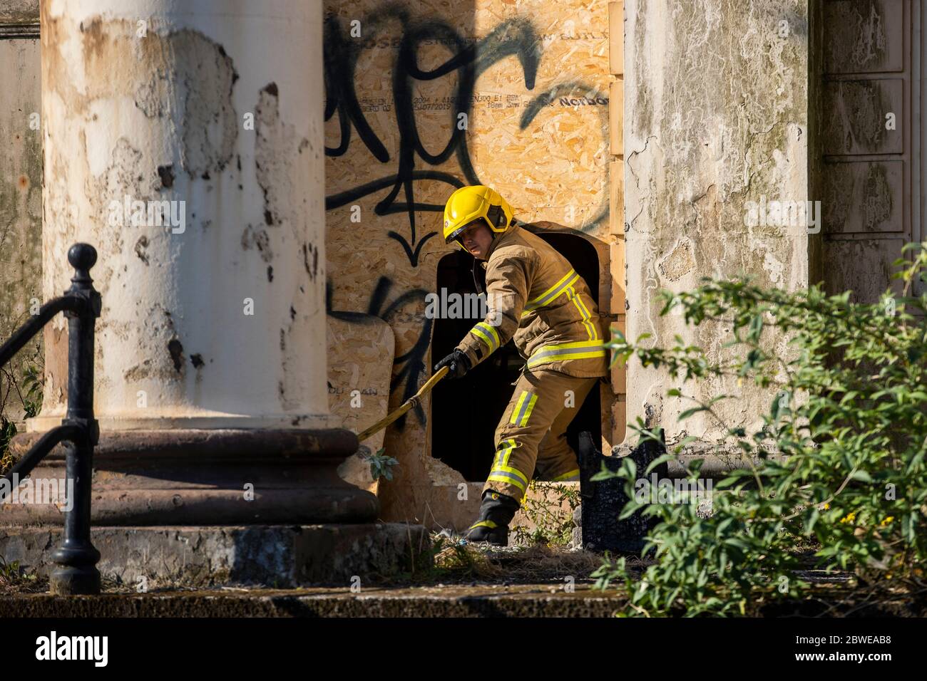 A Northern Ireland Fire and Rescue Service firefighter tackling a large ...