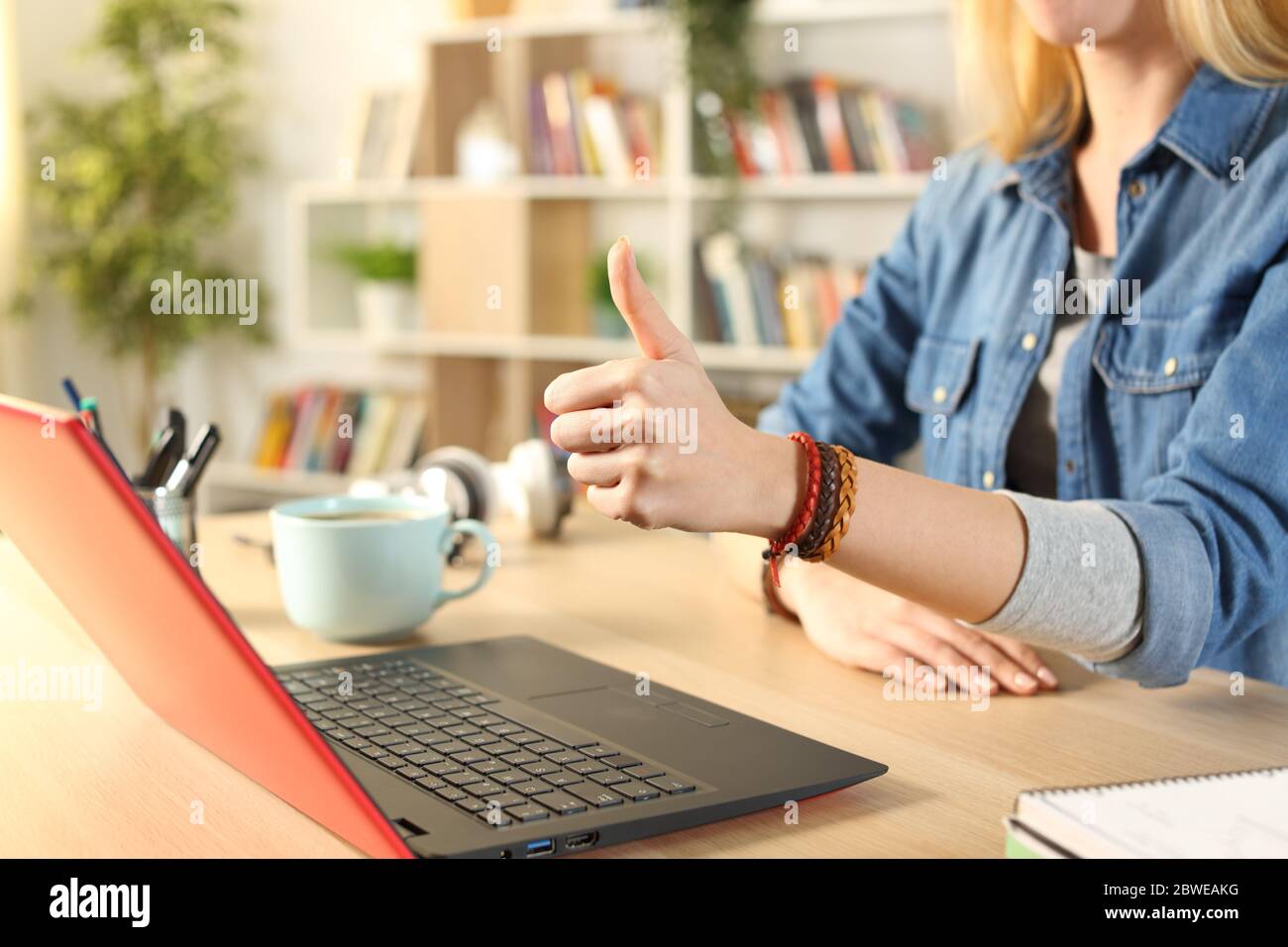 Female student hand up desk hi-res stock photography and images - Alamy