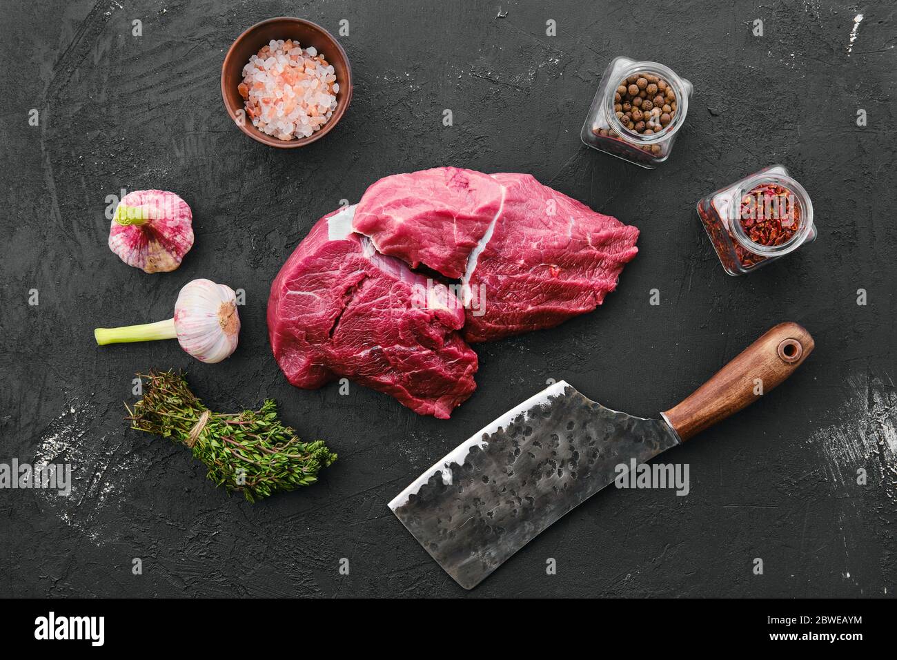 Raw fresh beef chuck eye roast on black background Stock Photo - Alamy