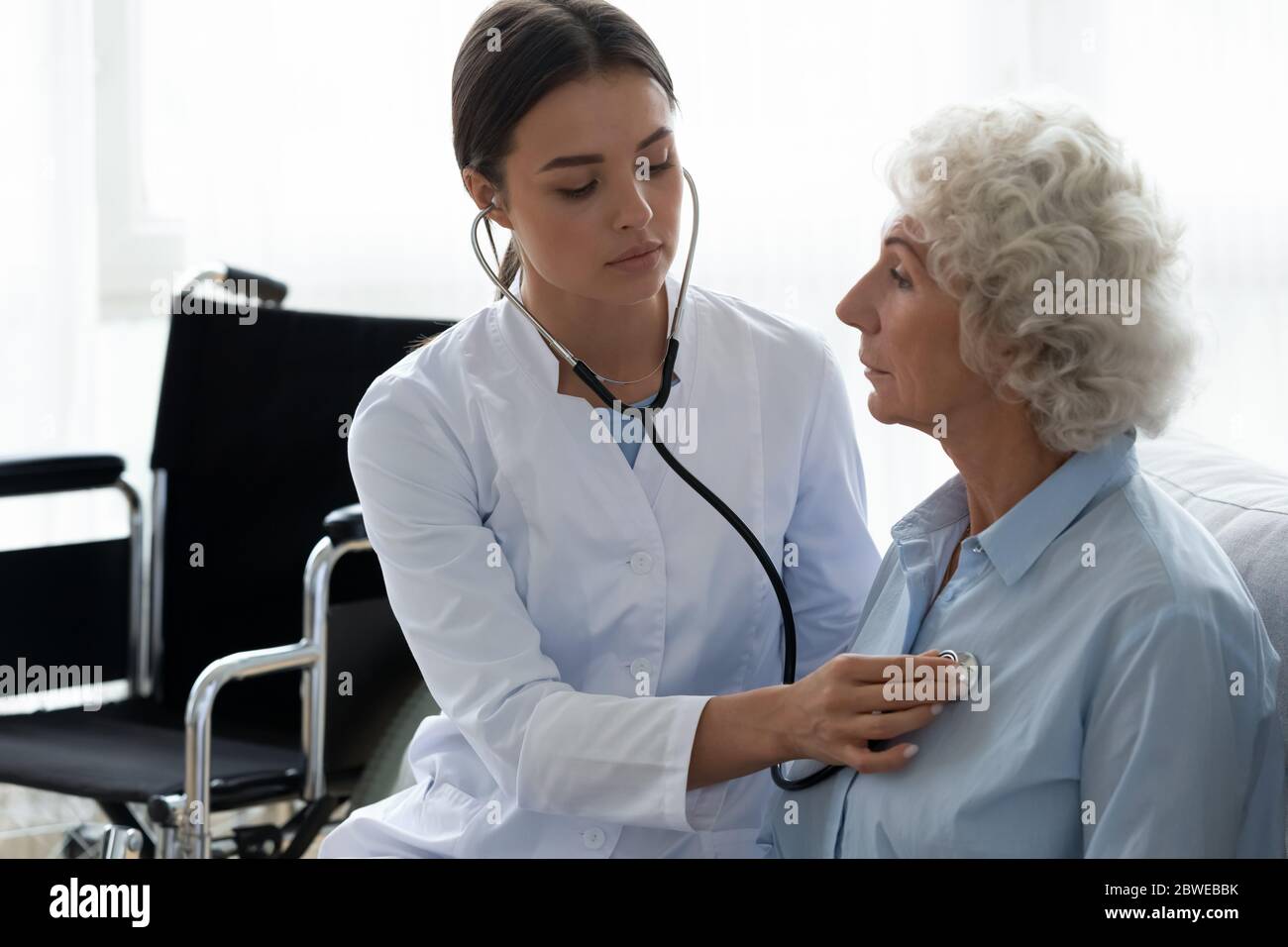 Woman doctor uses stethoscope listen hi-res stock photography and ...