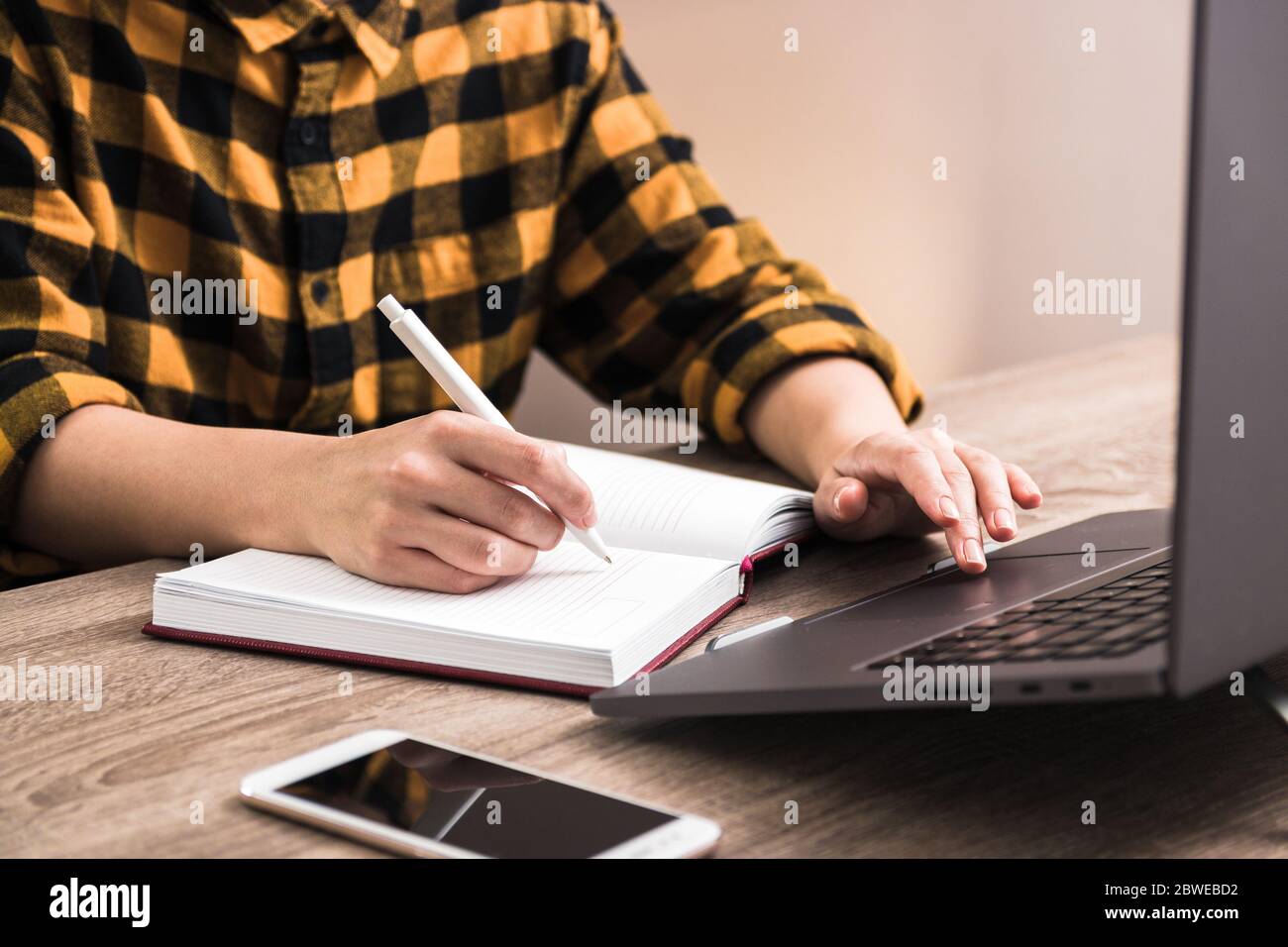 Closeup student takes exam online via internet on laptop and makes ...