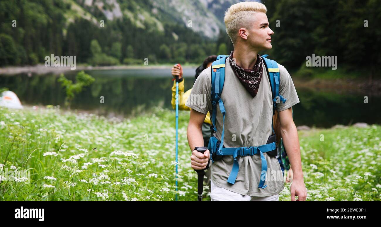 Adventure man hiking wilderness mountain with backpack Stock Photo - Alamy