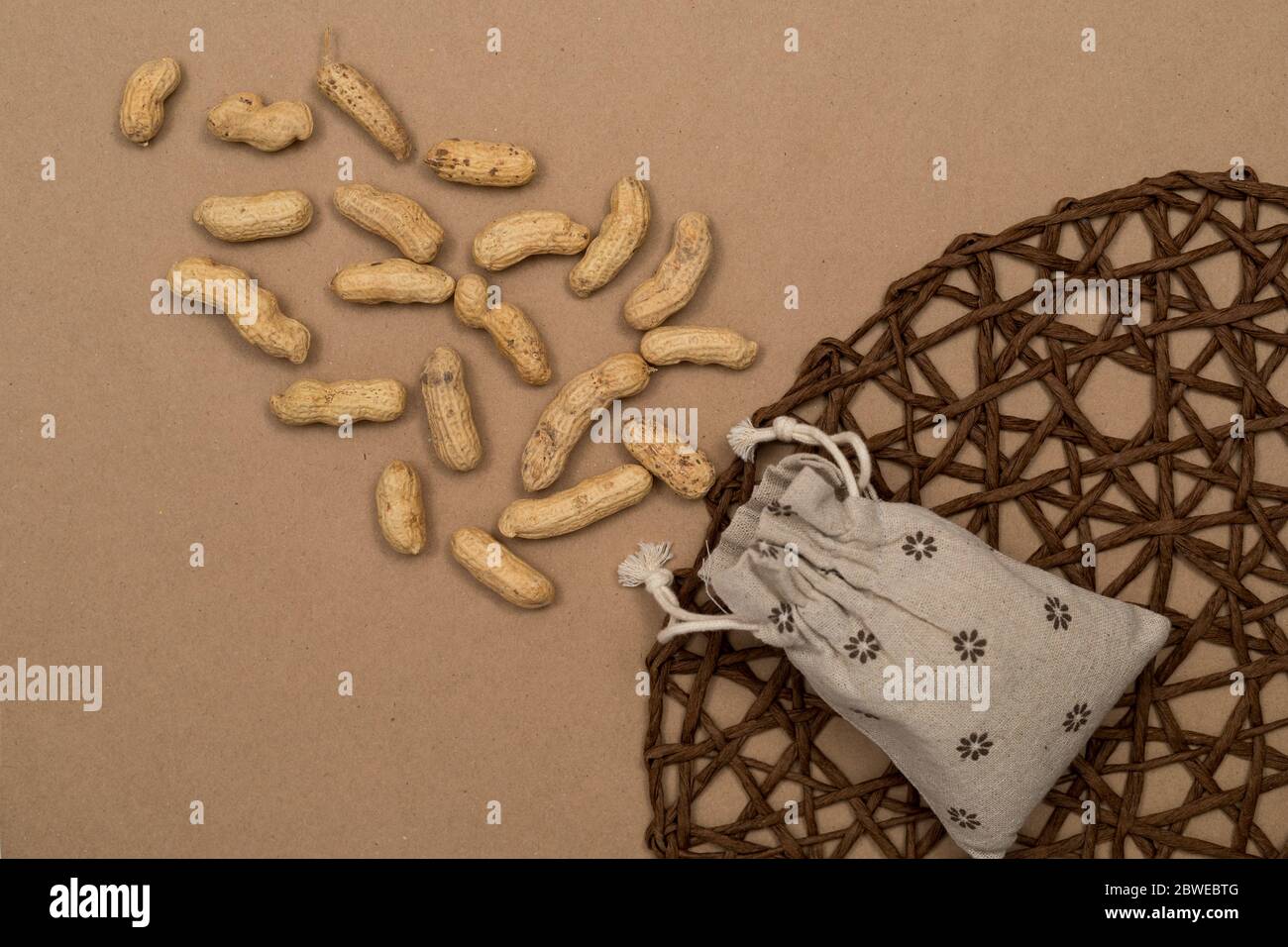Nuts, shelled peanuts, sprinkle on the table from a linen bag, kraft ...