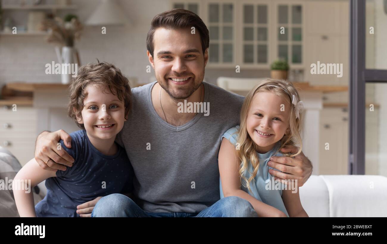 Portrait of young dad relax at home with small kids Stock Photo - Alamy