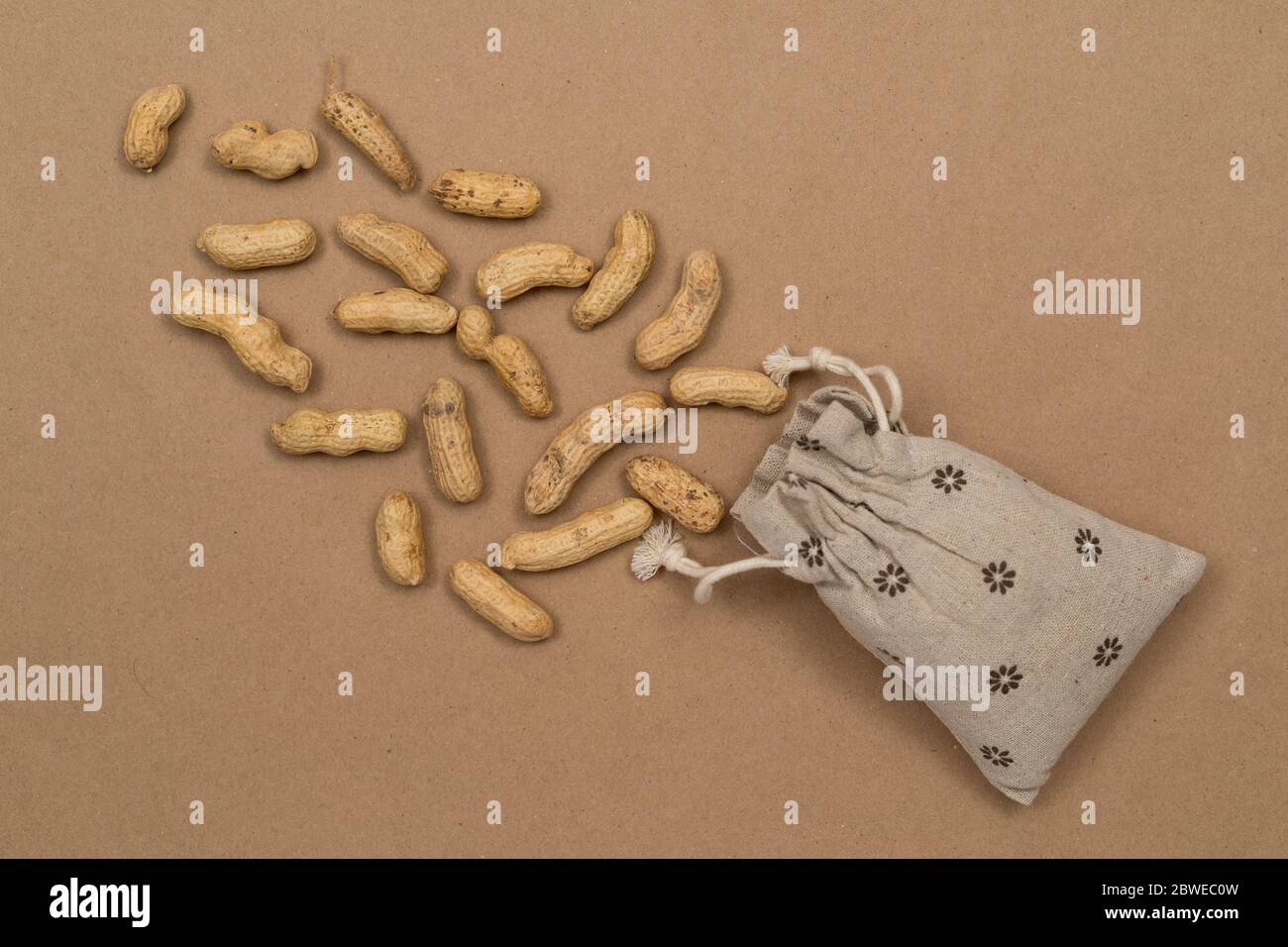 Nuts, shelled peanuts, sprinkle on the table from a linen bag, kraft ...