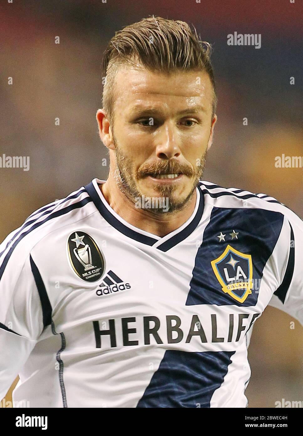 David Beckham wears pink football boots with his childrens names on ...