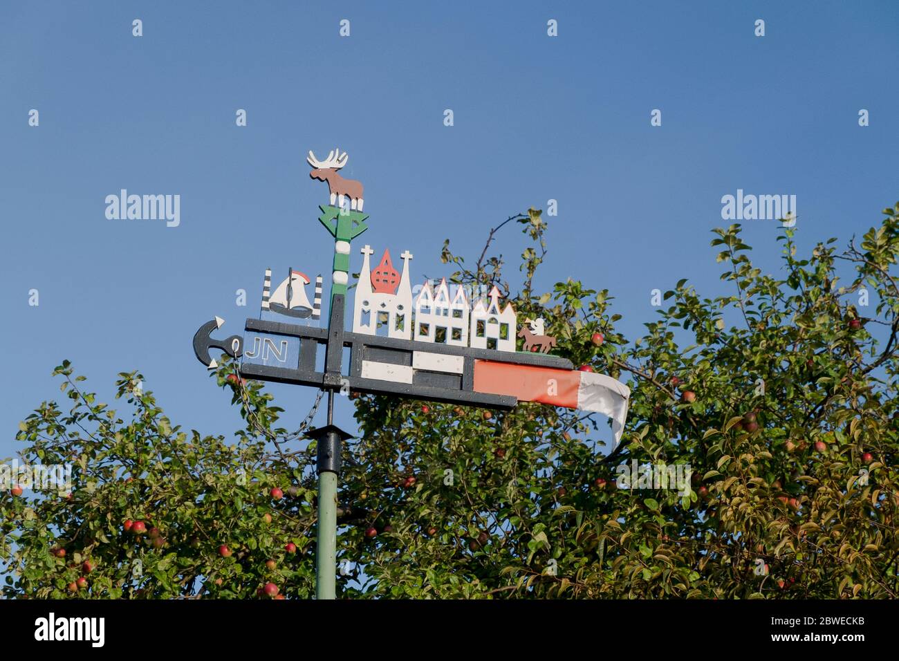 A classic, traditional, iconic wood mobile, carvings of a sailboat ...