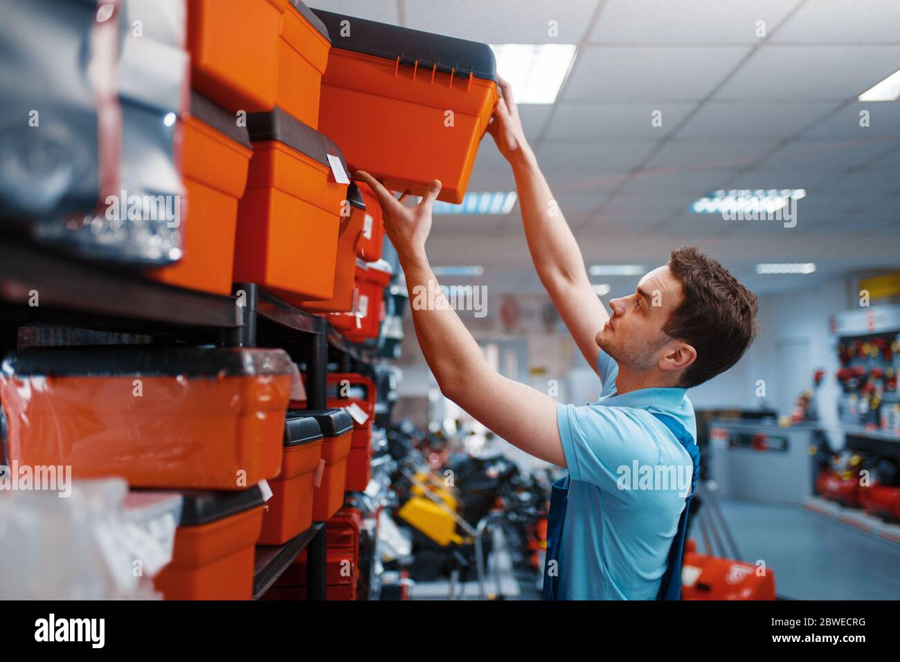 Male employee choosing toolbox in tool store Stock Photo - Alamy