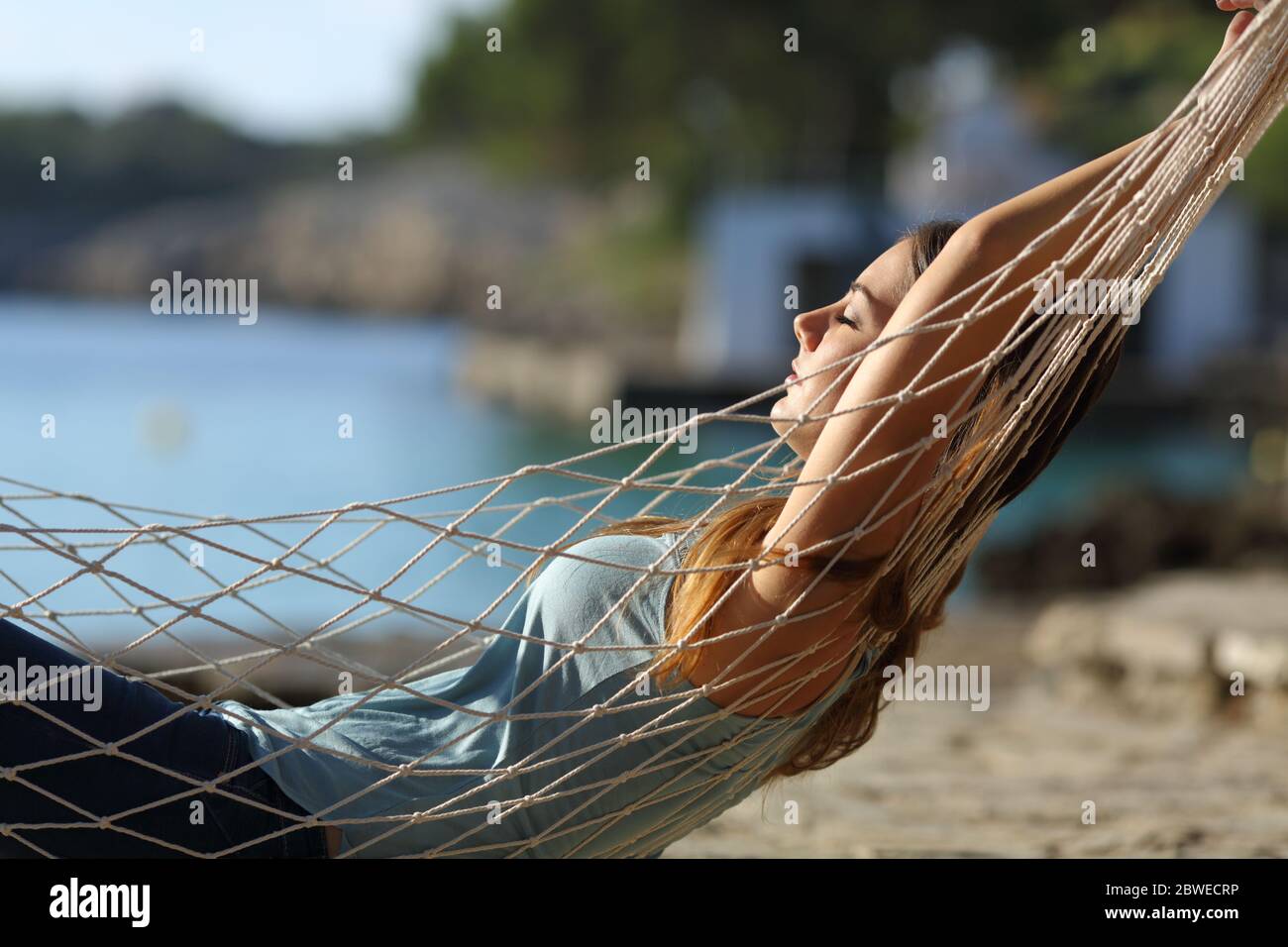 Lady sunbathing on the beach hi-res stock photography and images - Alamy
