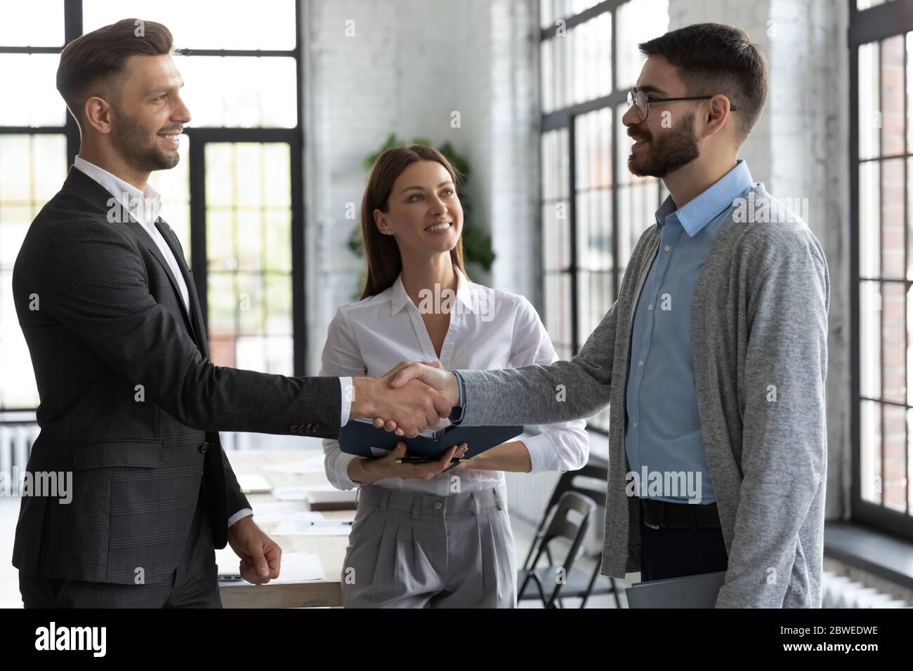 Confident business people handshaking, greeting and acquaintance Stock ...