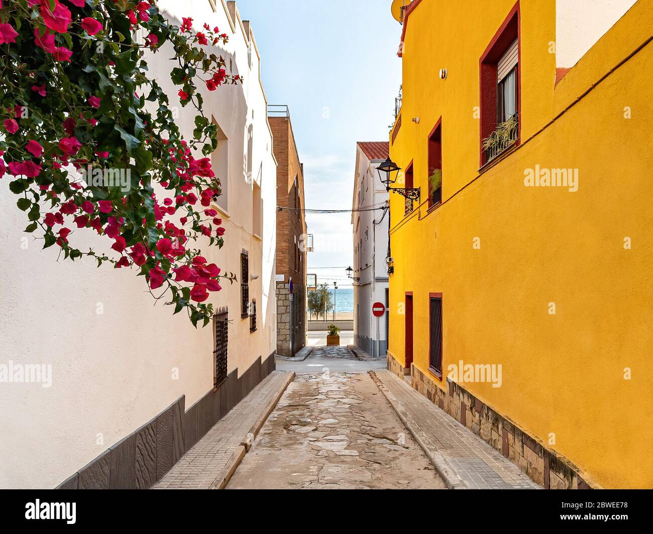The street leading to the beach and the sea in Masnou port town. El ...