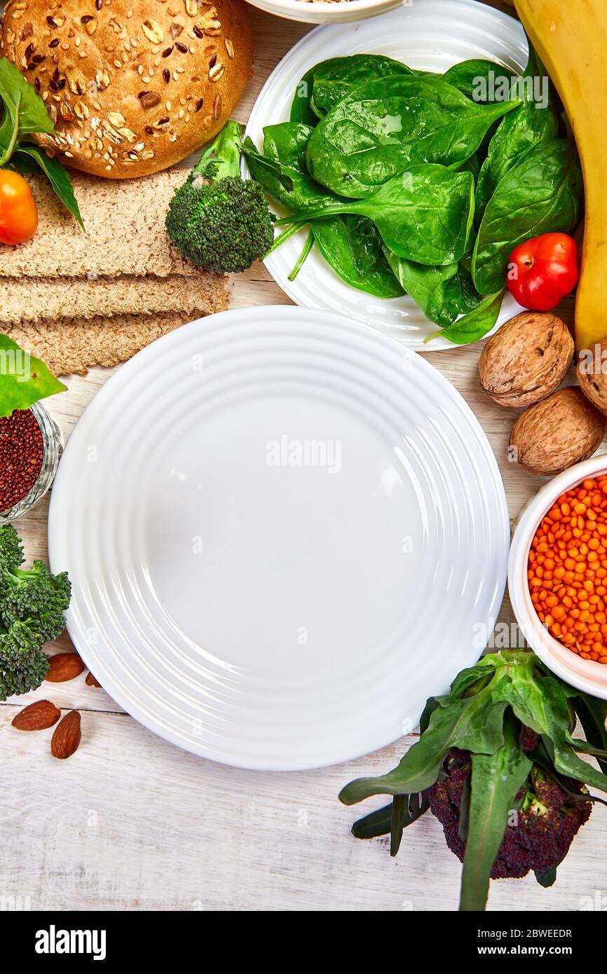 Selection food rich in fiber on white wooden background around empty ...