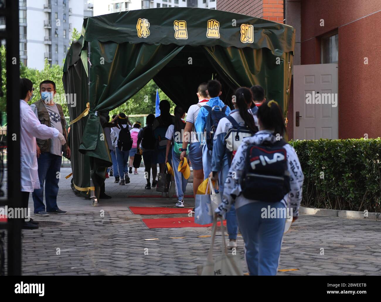 Beijing, China. 1st June, 2020. Students enter the school in Beijing ...
