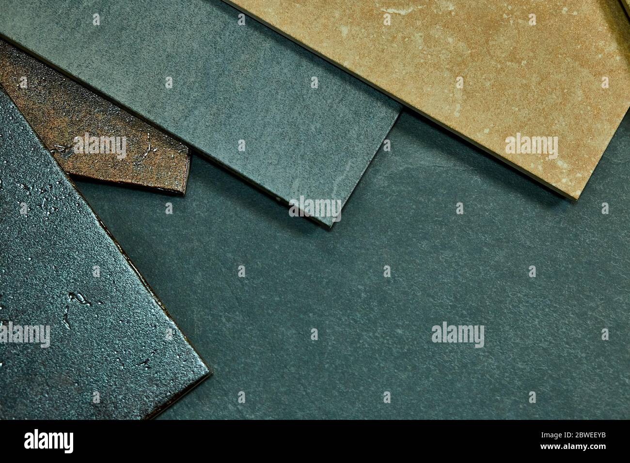 Frame of various different decorative tiles samples on stone background ...