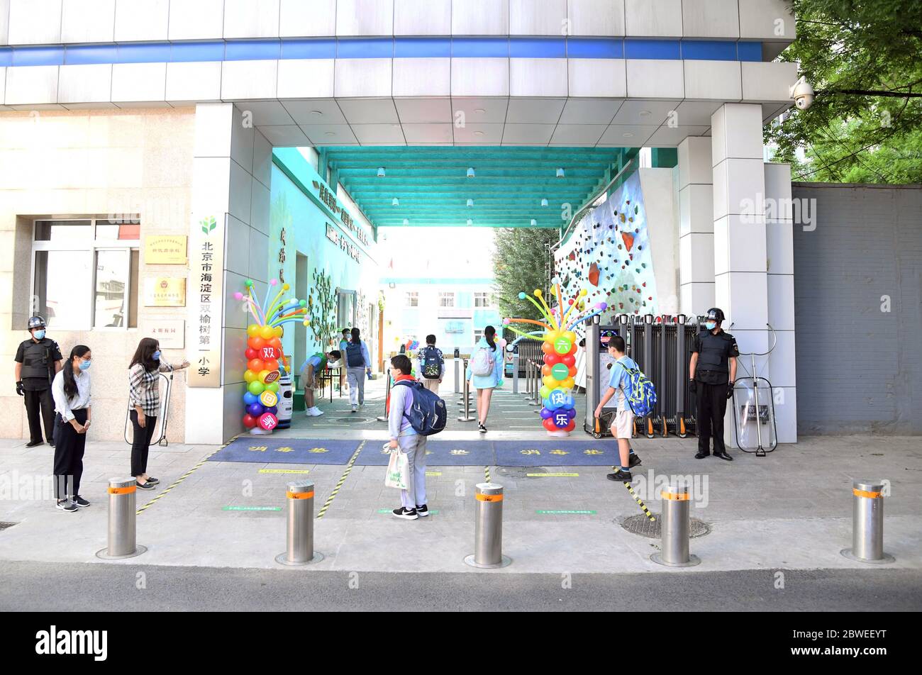 Beijing, China. 1st June, 2020. Students prepare to walk into the ...