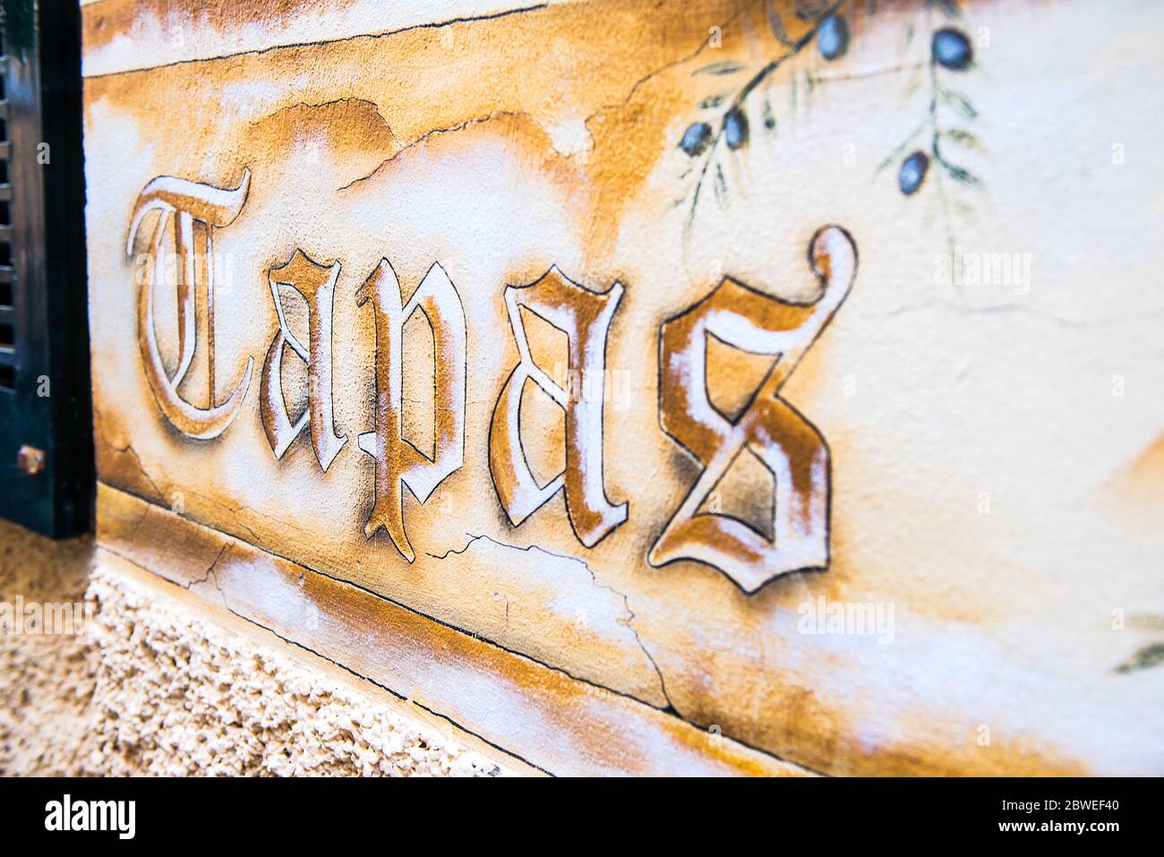 Hand painted Tapas sign on exterior wall of restaurant at Sineu in ...