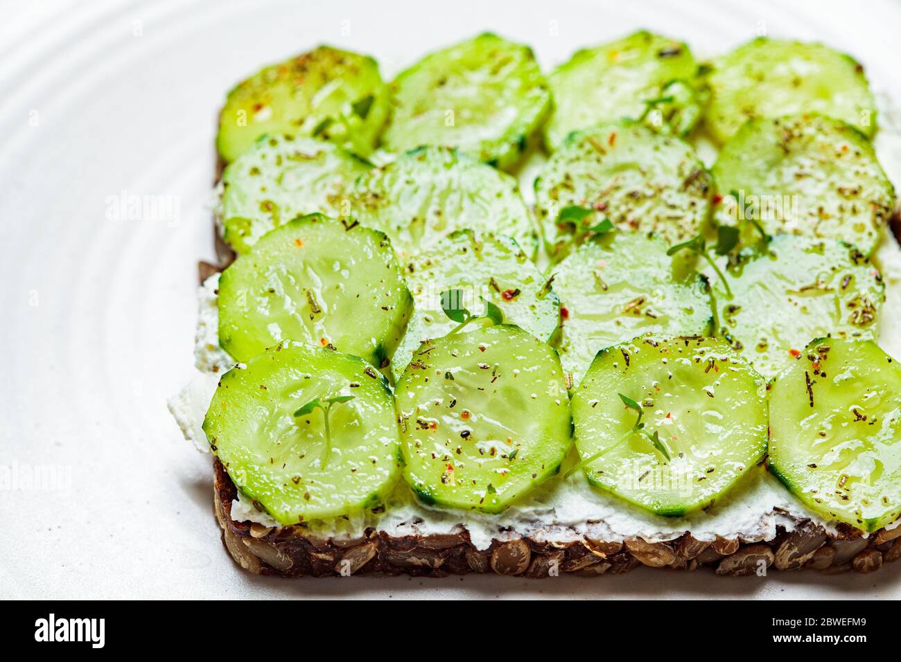 Cucumber and cream cheese toast on a plate. Healthy vegetarian diet ...