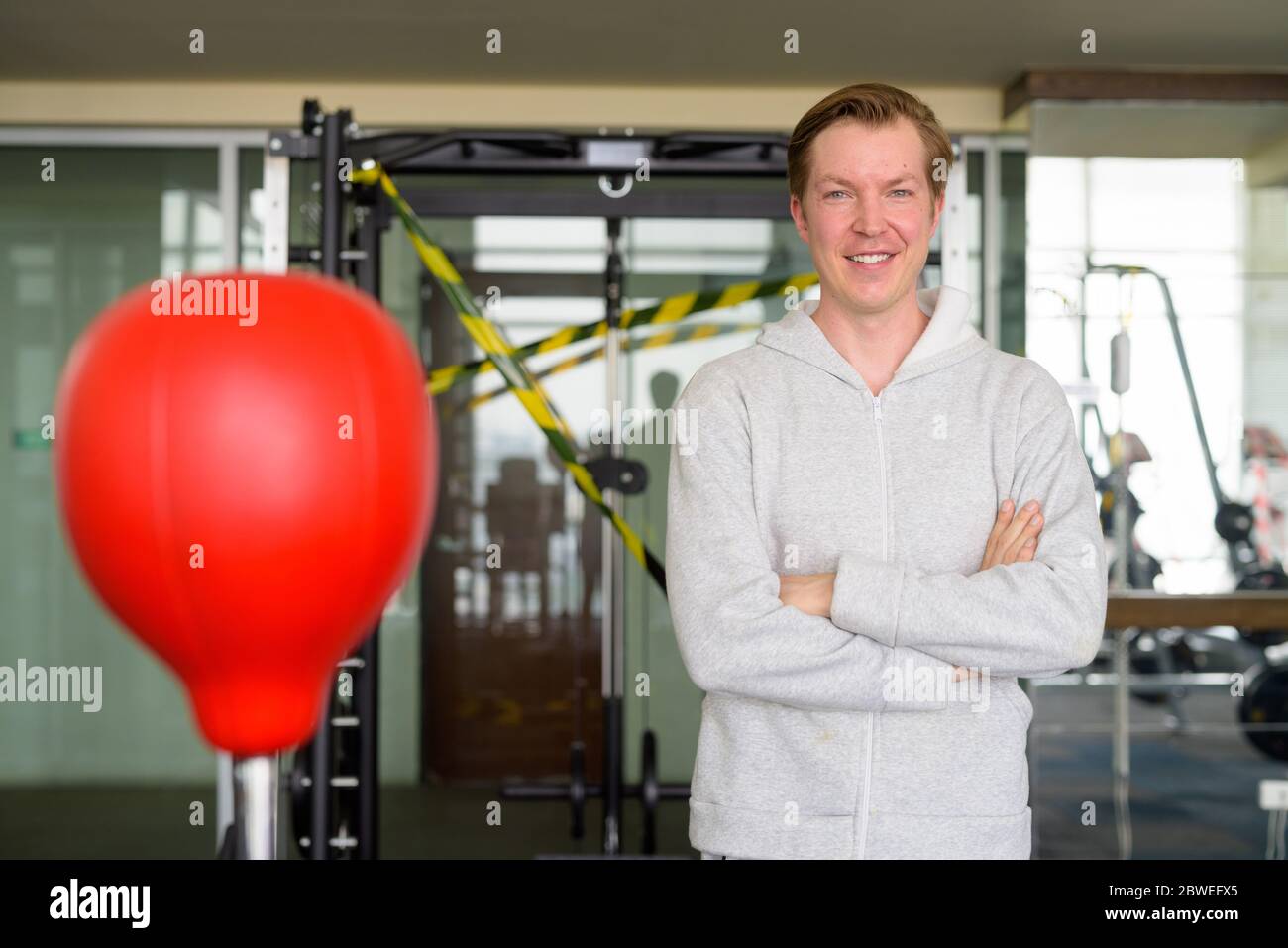 Happy young man with arms crossed ready for boxing at the gym Stock ...