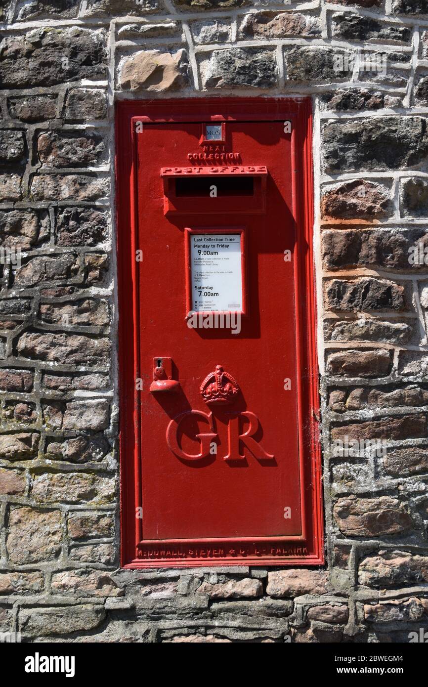 A red traditional Royal Mail Postbox embedded into a wall in Clifton ...
