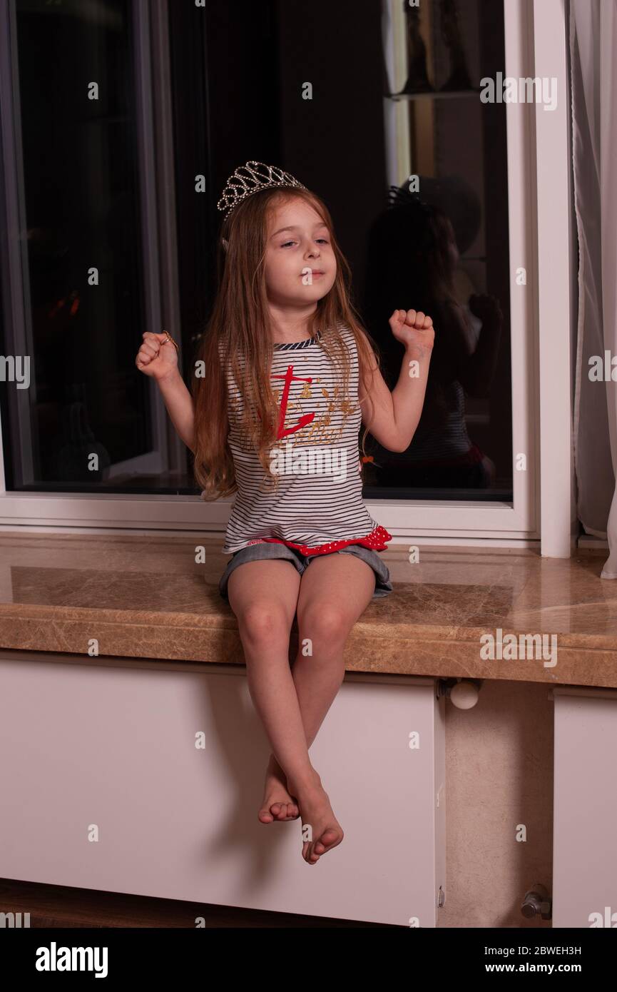 Cute Little Girl Sitting On Windowsill Girl 5 Years Old With A Crown