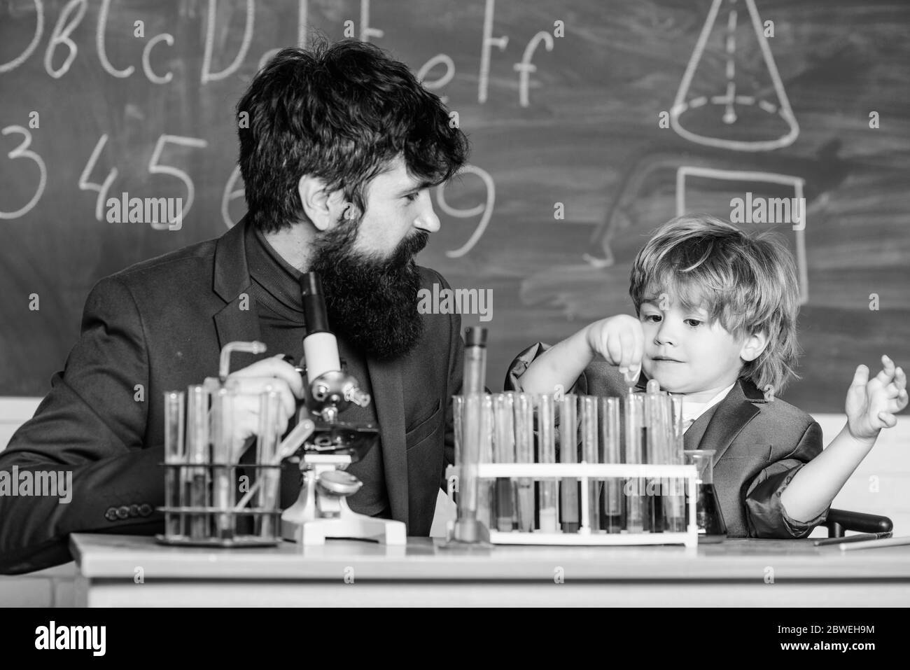 Back to school. father and son at school. school kid scientist studying ...