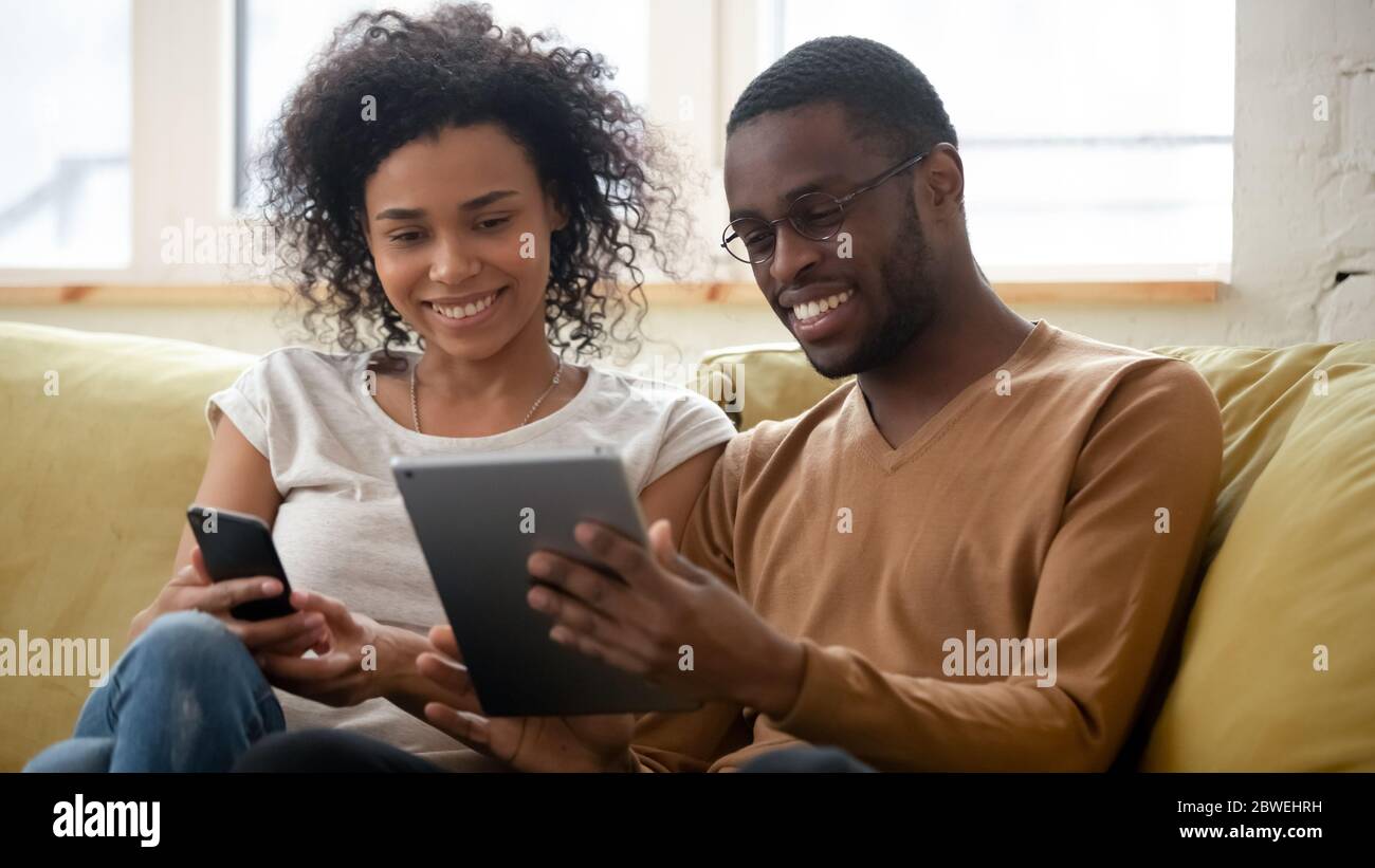 Family using electronic gadgets hi-res stock photography and images - Alamy