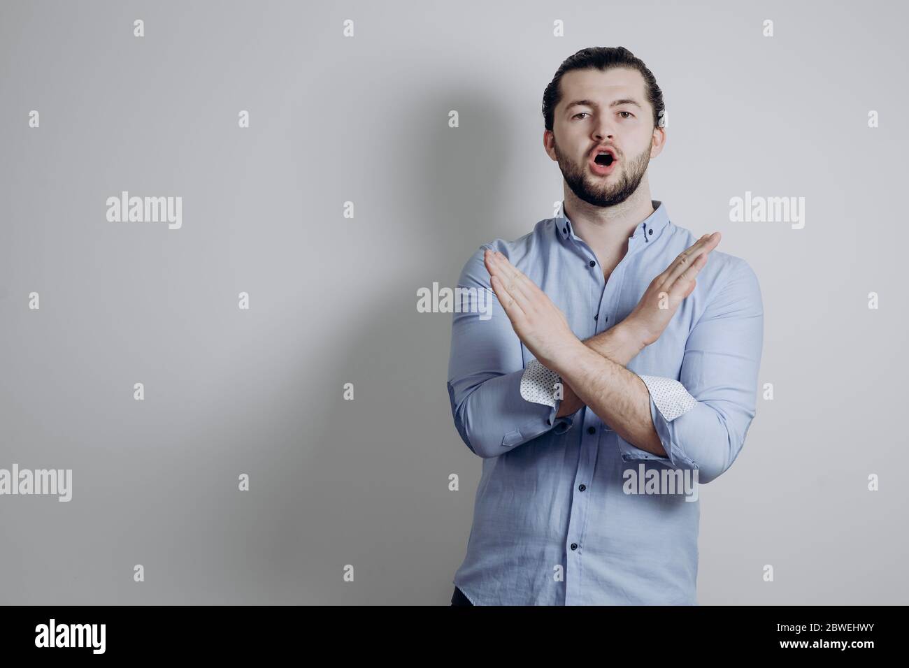 Man on a gray background. Shows hands stop. Stop racism. Stop virus ...