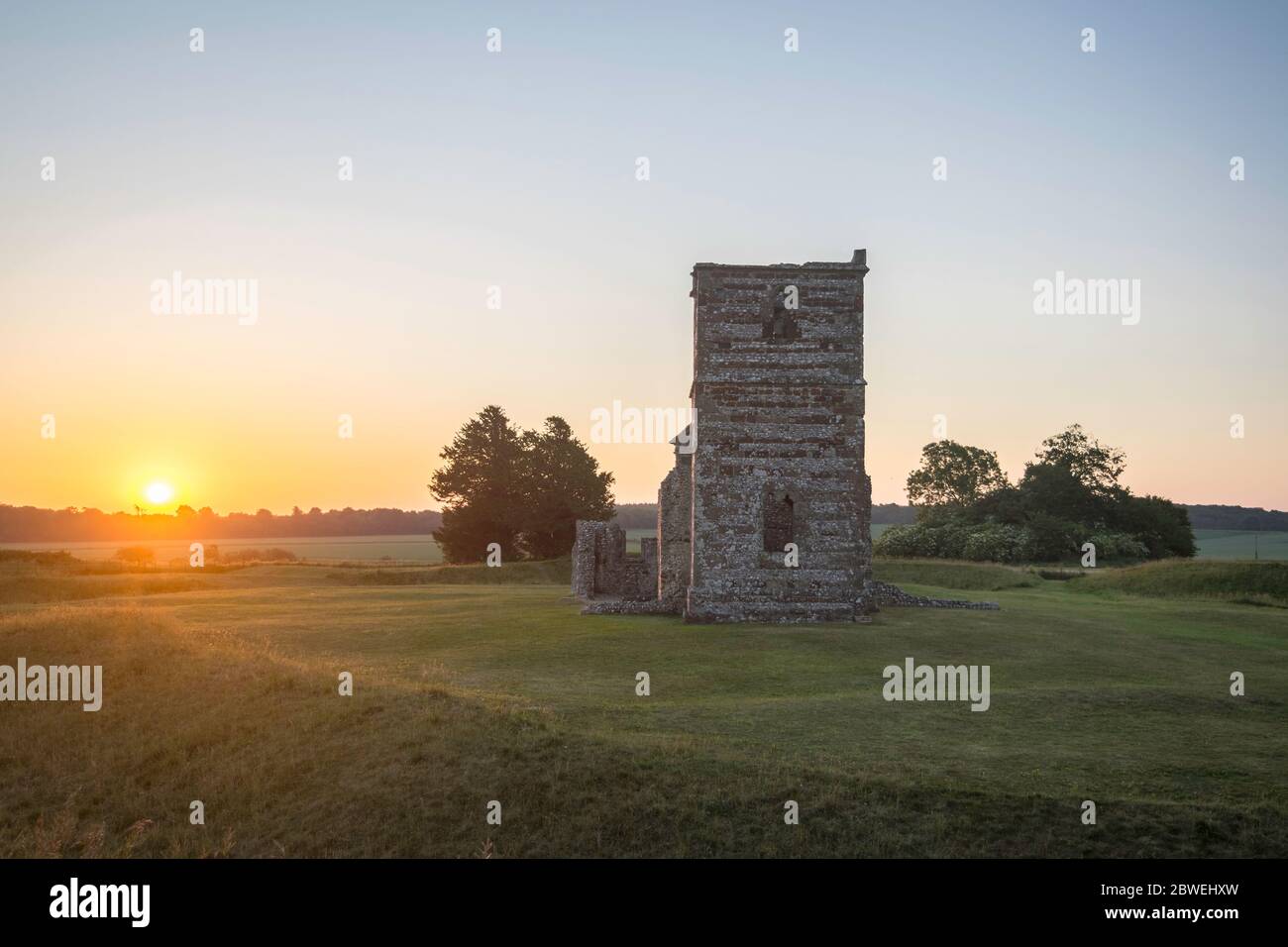 Sunrise at Knowlton Church and Earthworks with the surounding neolithic ...