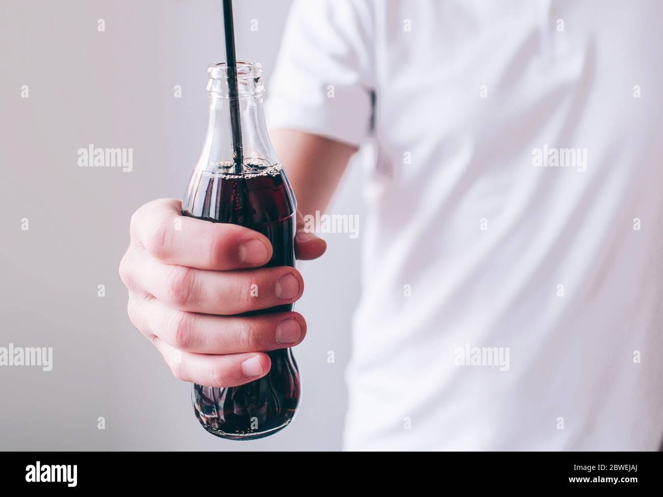 Young man isolated over background. Cut view of male's hand holding ...